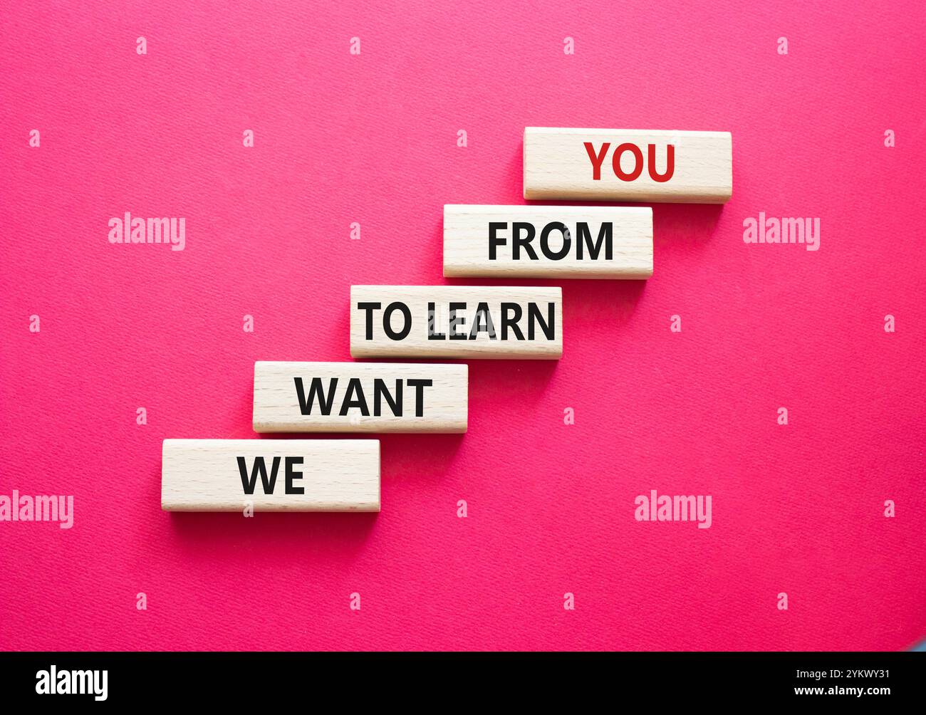We want to learn from you symbol. Wooden blocks with words We want to ...