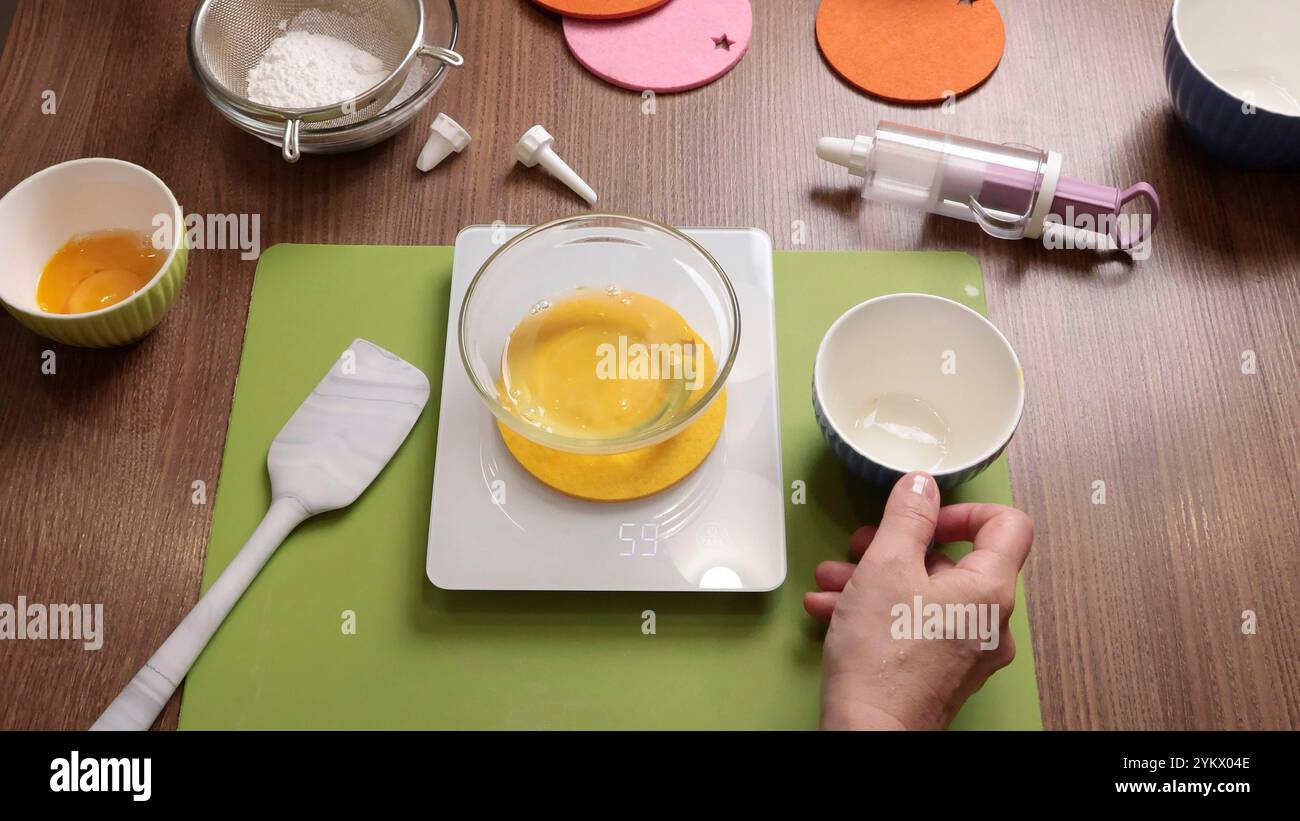 Process of preparing scales and utensils for making dough. Woman weighs ...
