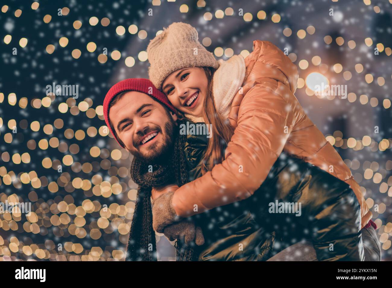 Photo of jolly guy hugging piggyback his beloved girlfriend under x-mas ...