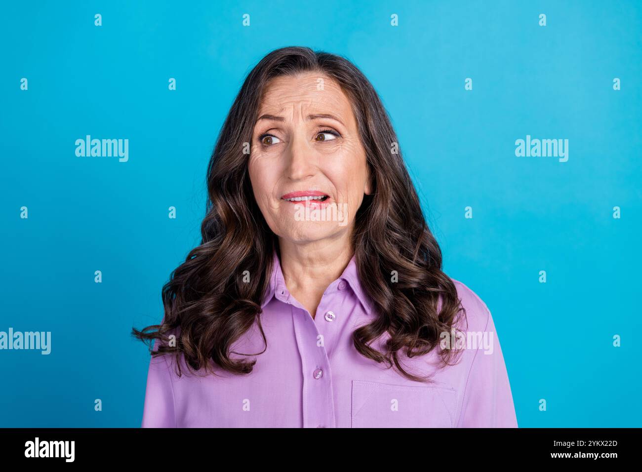 Photo of doubtful pretty lady dressed puple blouse looking empty space ...