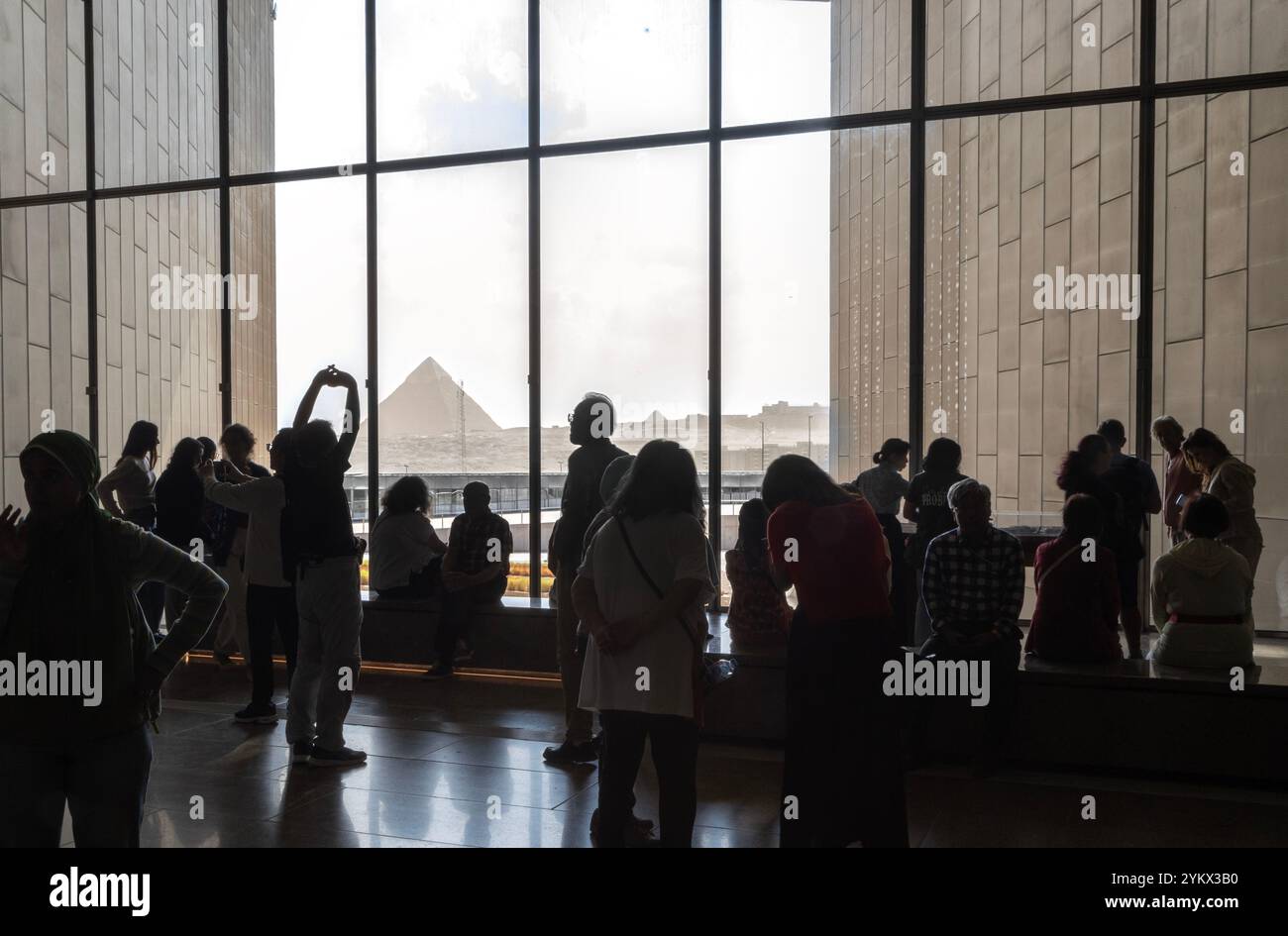 Visitors admire the panoramic view of the pyramids of Giza from the top ...