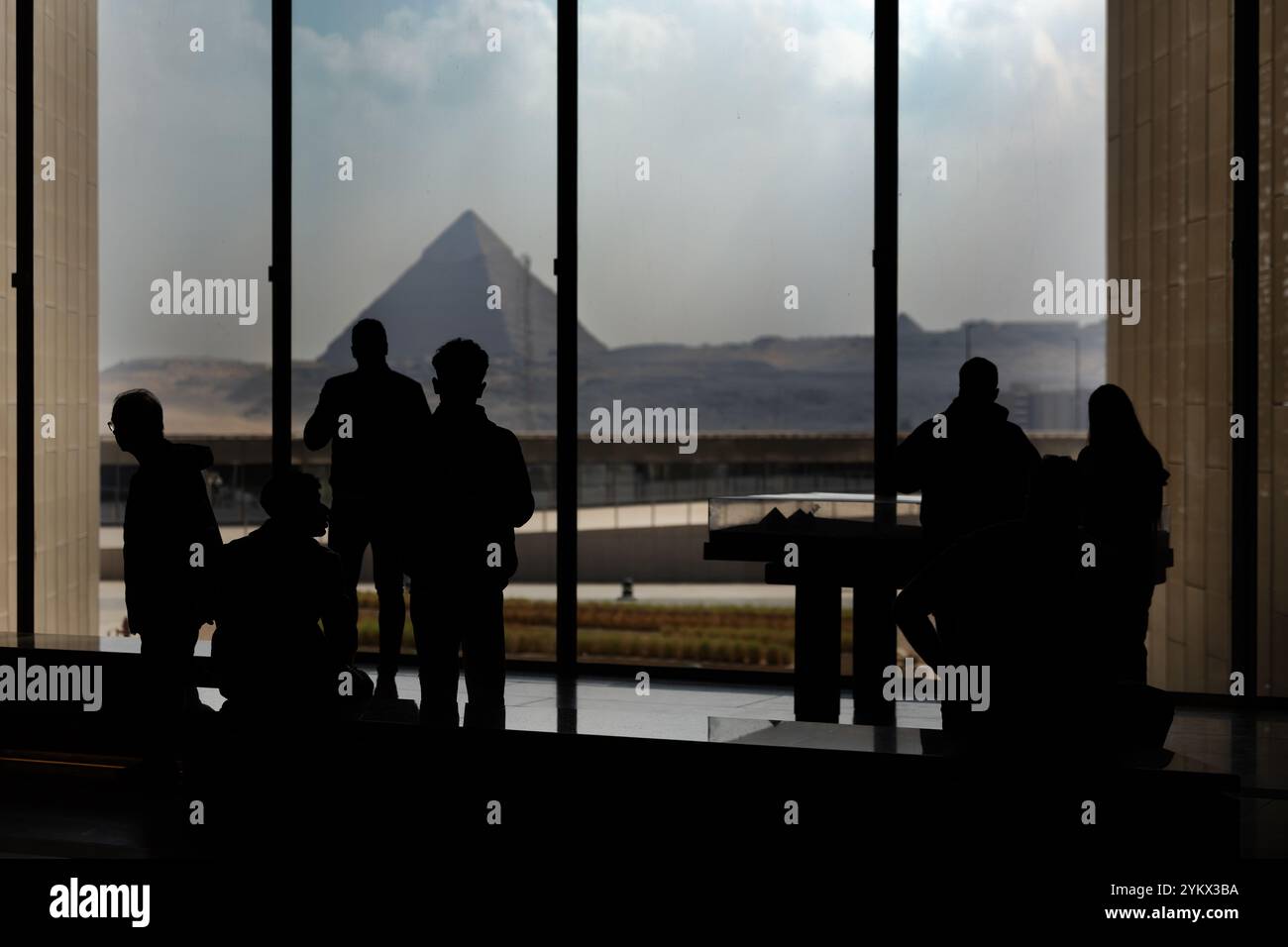 Visitors silhouetted against the pyramids at Giza at the top of the ...