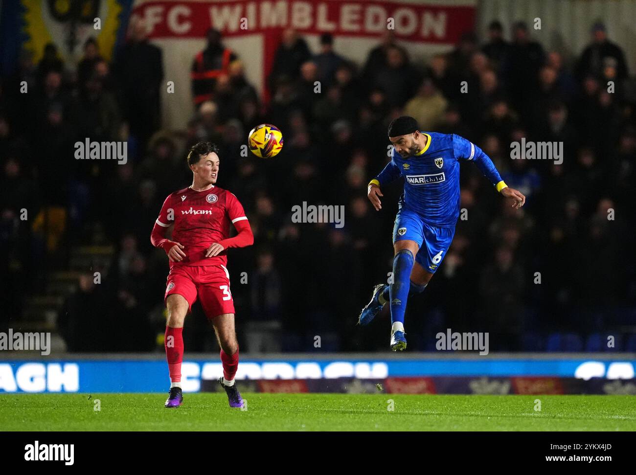 Accrington Stanley's Josh Woods (left) and AFC Wimbledon's Ryan Johnson ...