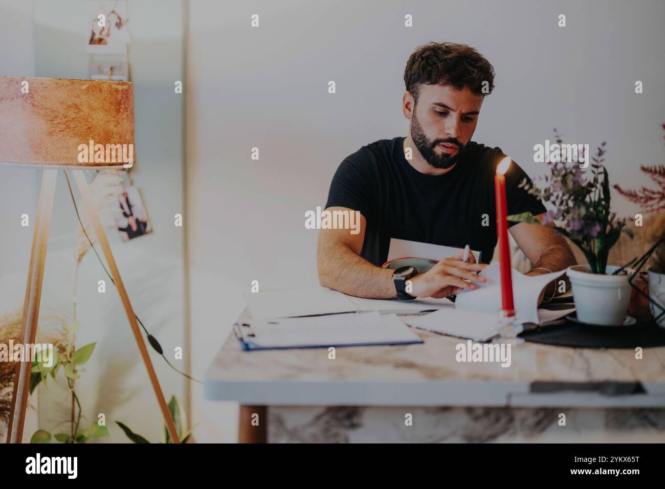 Young college student studying at home with focused concentration Stock ...