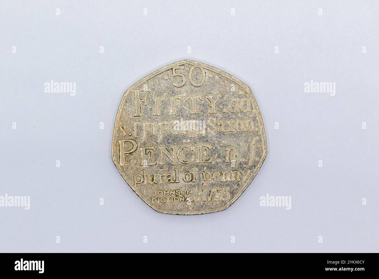 A close-up view of a fifty pence coin featuring text detailing its ...