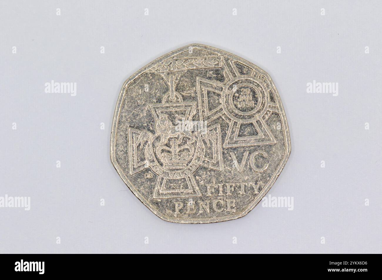 A close-up shot of a British fifty pence coin featuring the Victoria ...