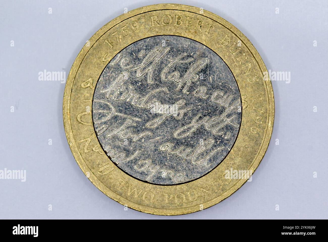 A close-up image of a British two-pound coin, featuring a silver center ...