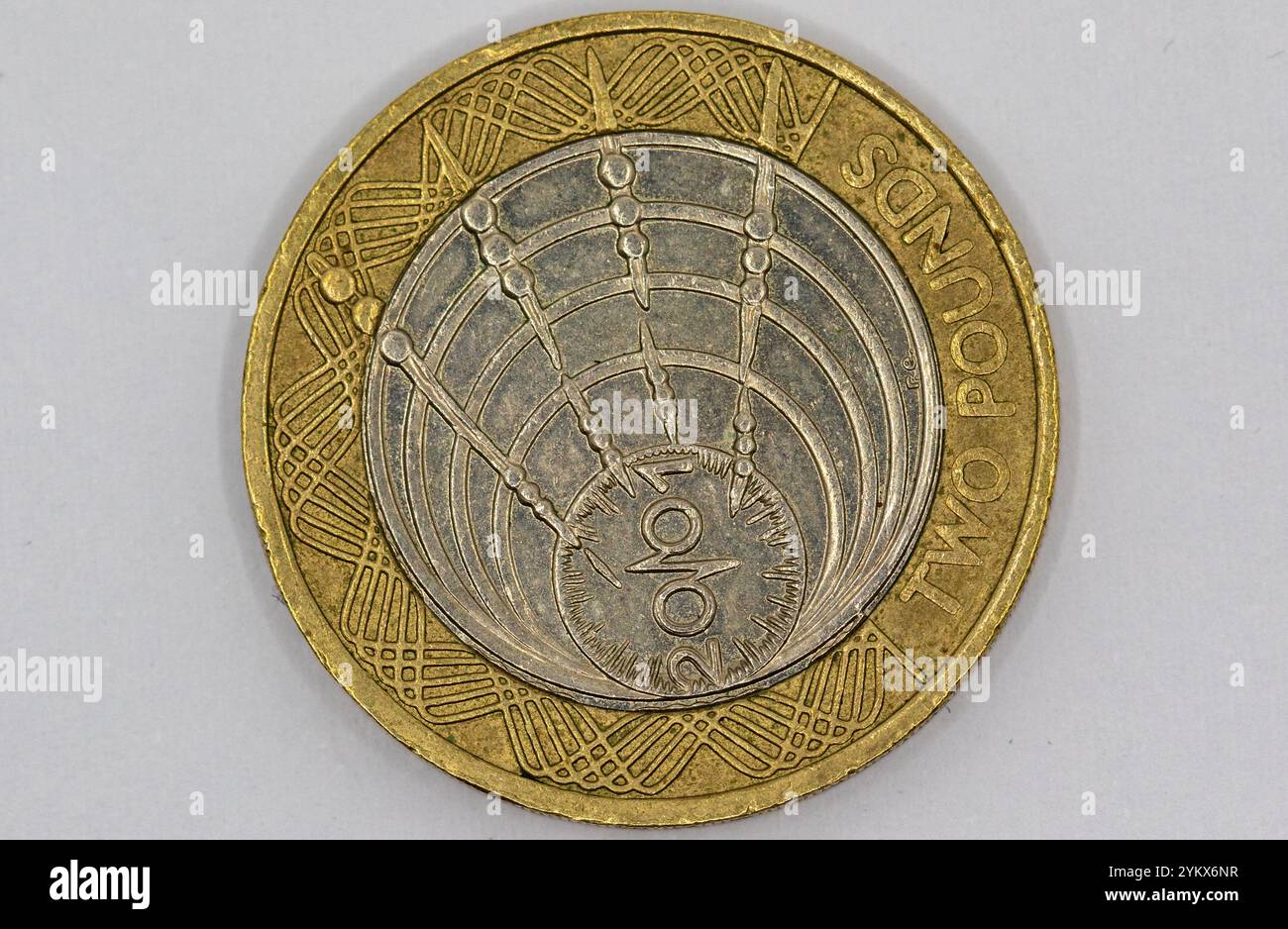 Close-up view of a British two-pound coin, featuring a bicameral design ...