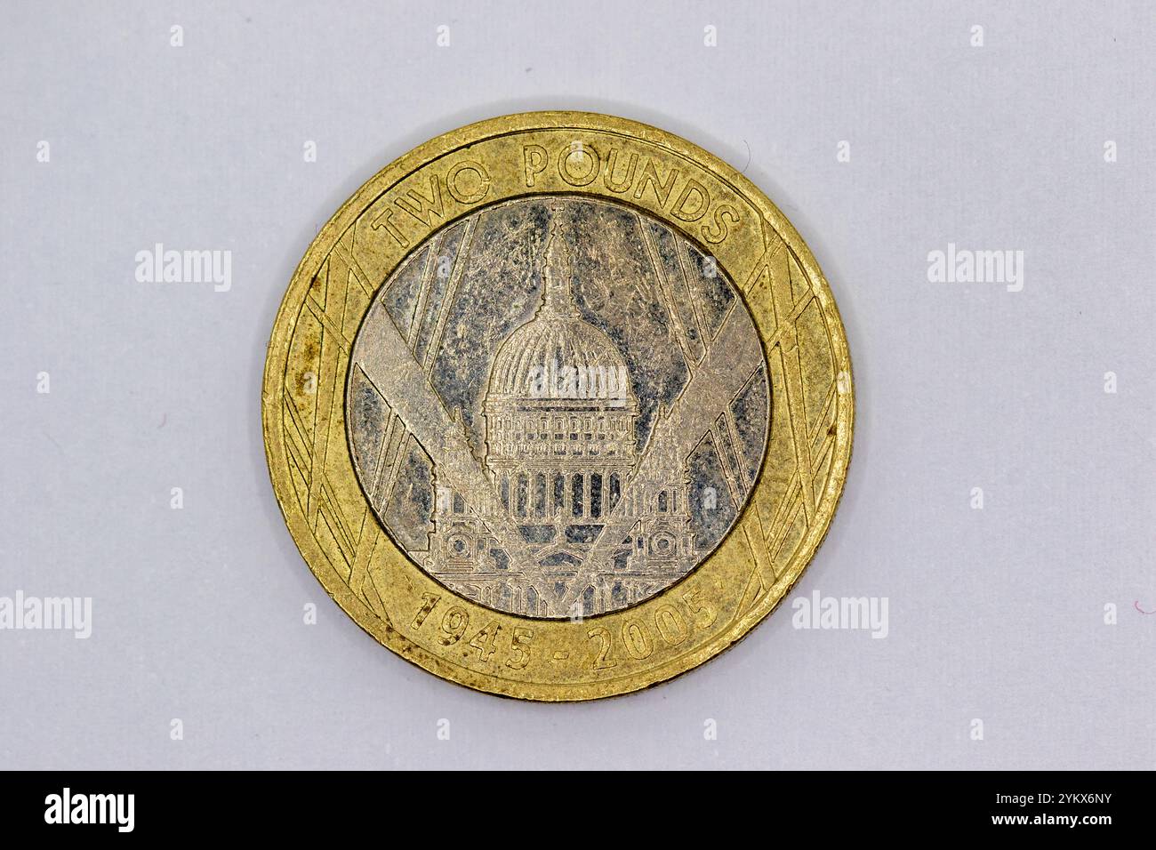 Close-up view of a worn, gold-colored British two-pound coin, featuring ...
