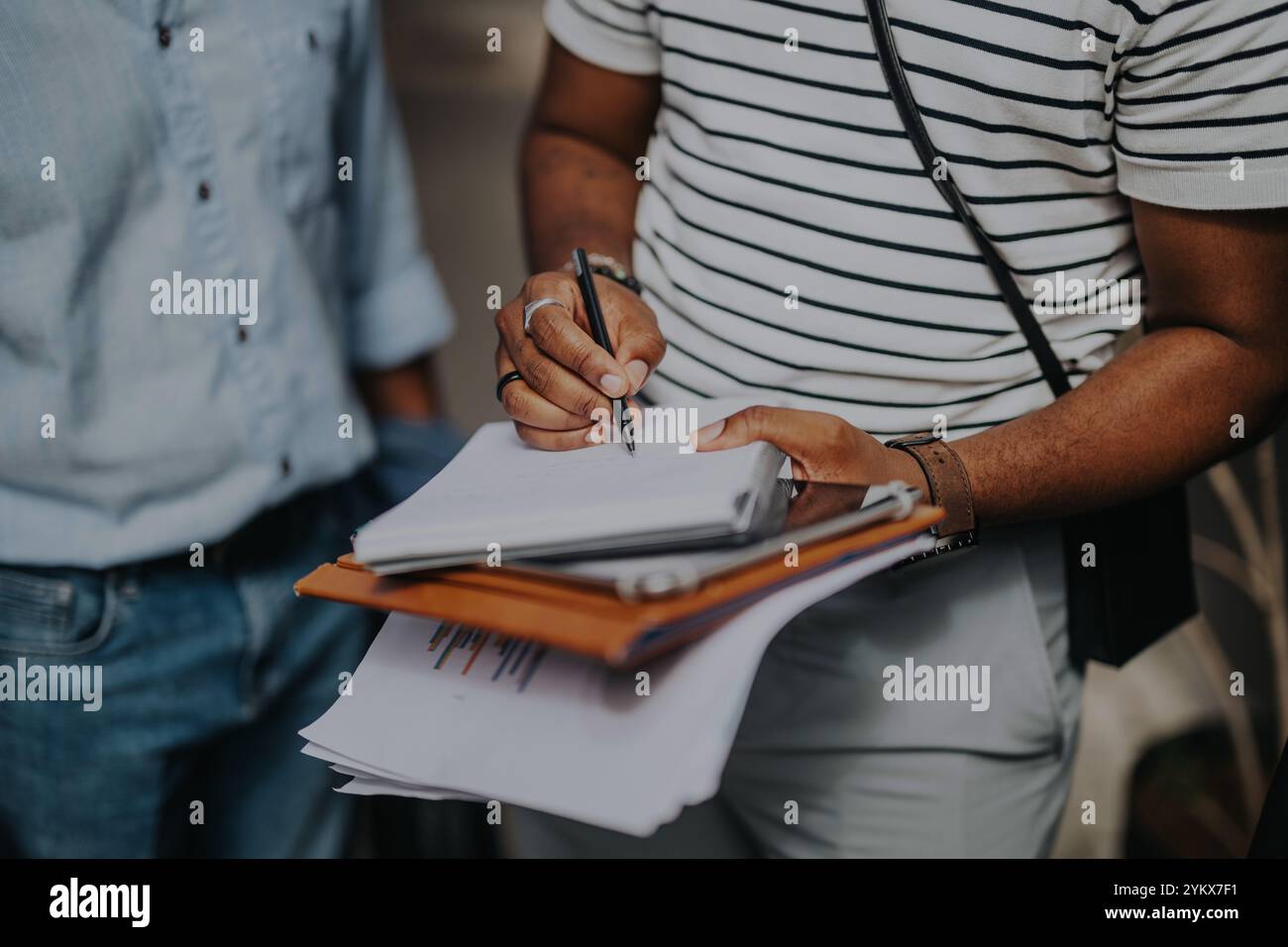 Collaborative business meeting outdoors with note-taking Stock Photo ...