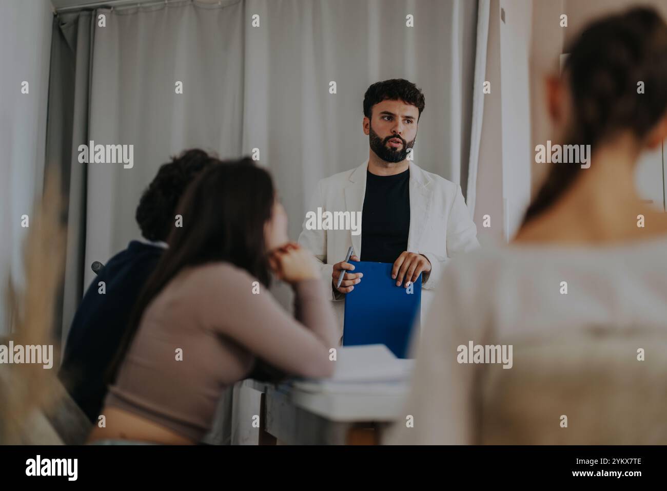 High school students learning with professor in a cozy home environment Stock Photo - Alamy