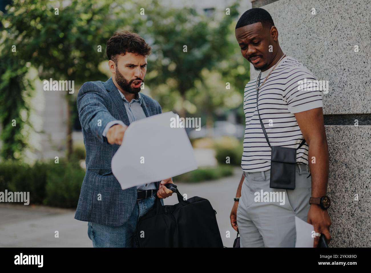 Business people engaged in a dynamic outdoor urban meeting Stock Photo ...