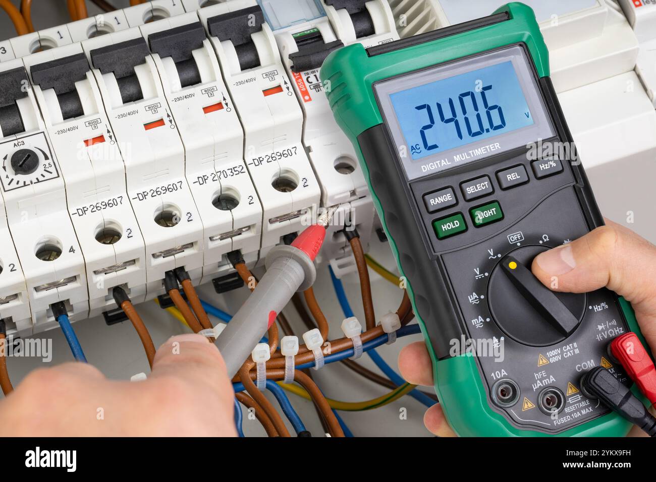 Electrician Testing Voltage in Circuit Breaker System with Multimeter ...