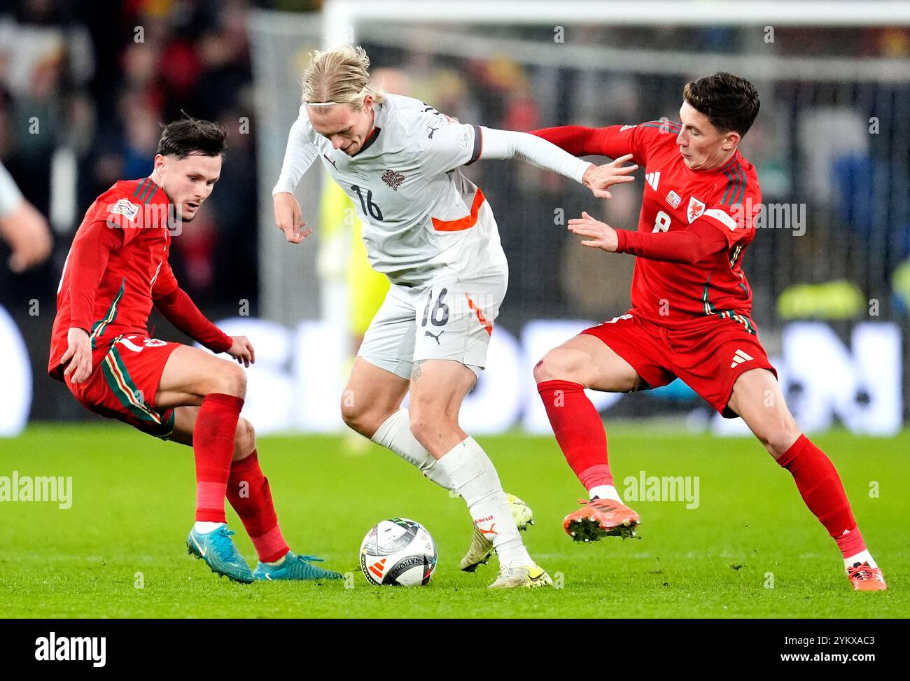 Iceland's Stefan Thordarson (centre) battles for the ball with Wales ...