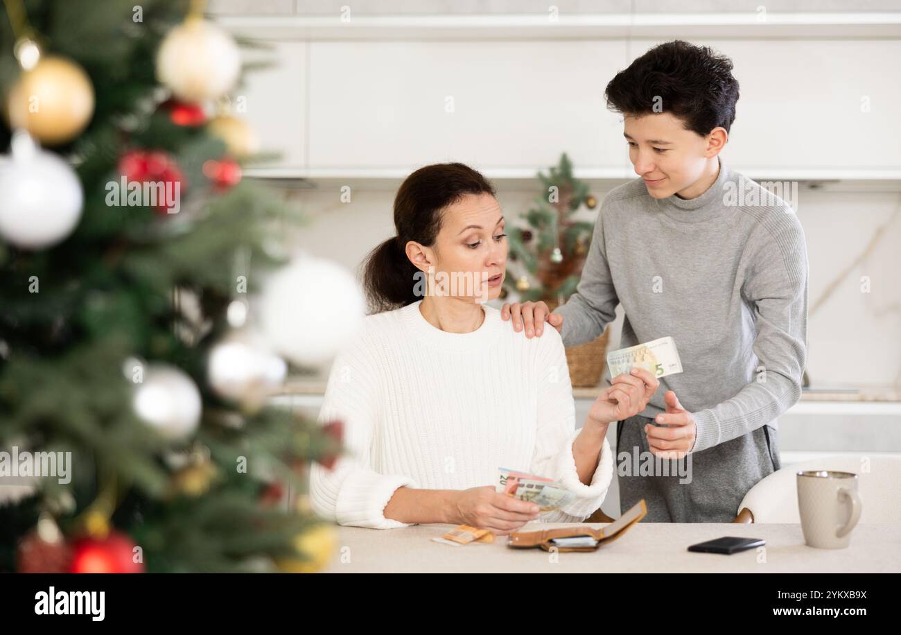 Boy asking mother for money Stock Photo - Alamy
