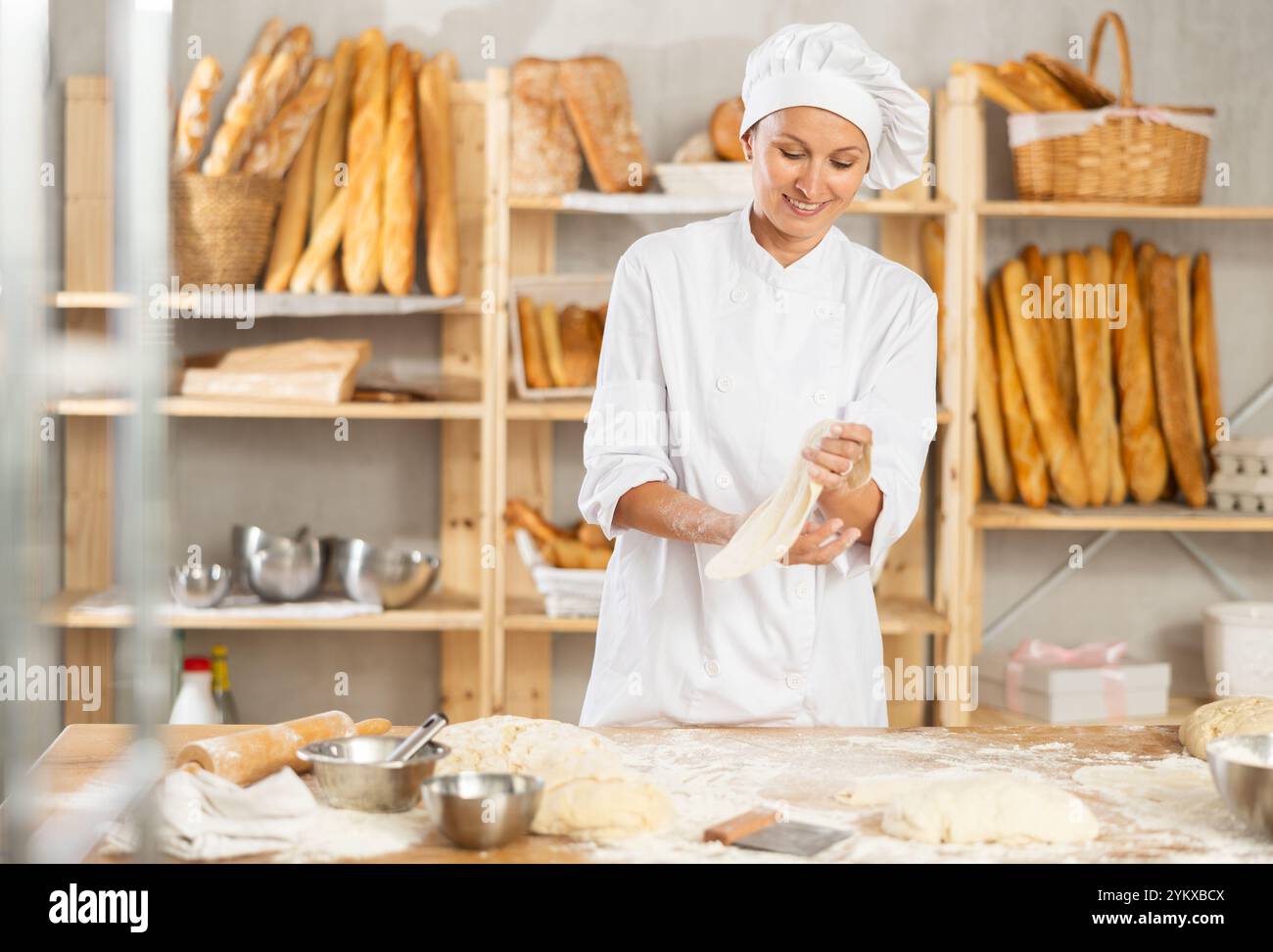 Female baker flattening dough hi-res stock photography and images - Alamy