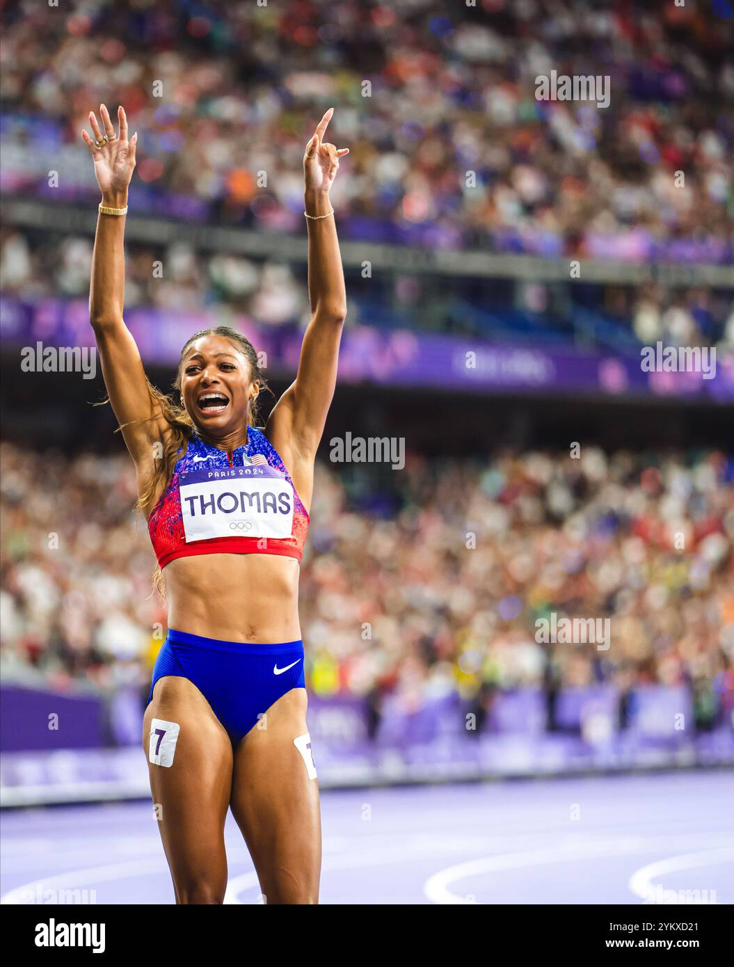 Gabrielle Thomas celebrating with her country's flag in the 200 meters ...