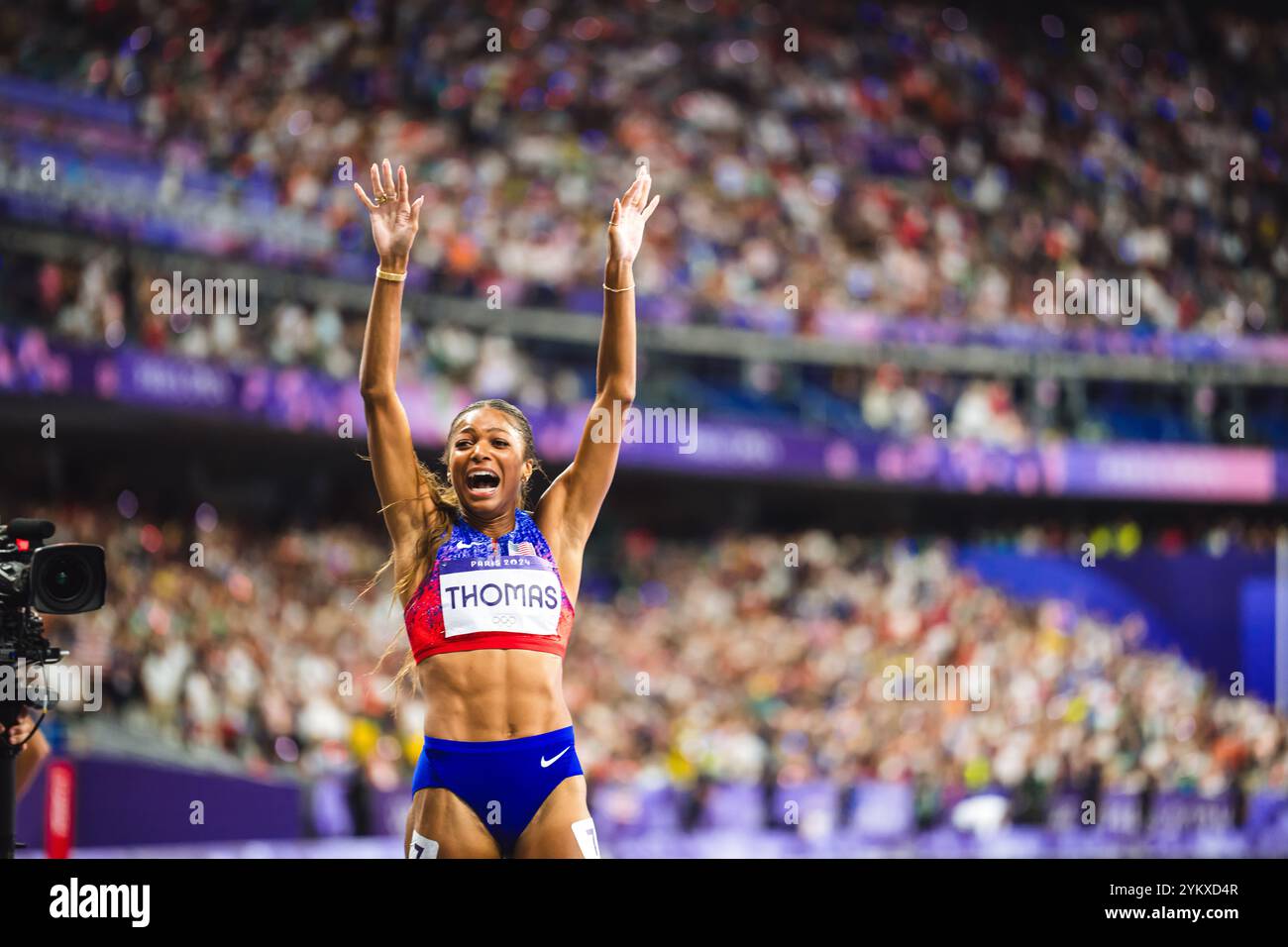 Gabrielle Thomas celebrating with her country's flag in the 200 meters ...