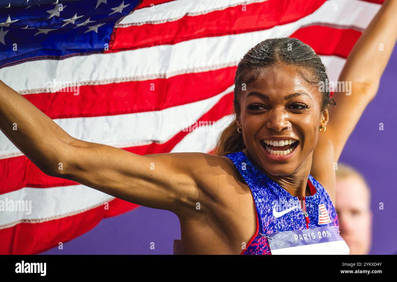 Gabrielle Thomas celebrating with her country's flag in the 200 meters ...