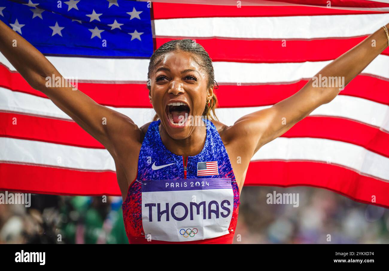 Gabrielle Thomas celebrating with her country's flag in the 200 meters ...