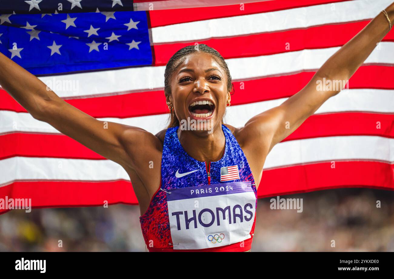 Gabrielle Thomas celebrating with her country's flag in the 200 meters ...
