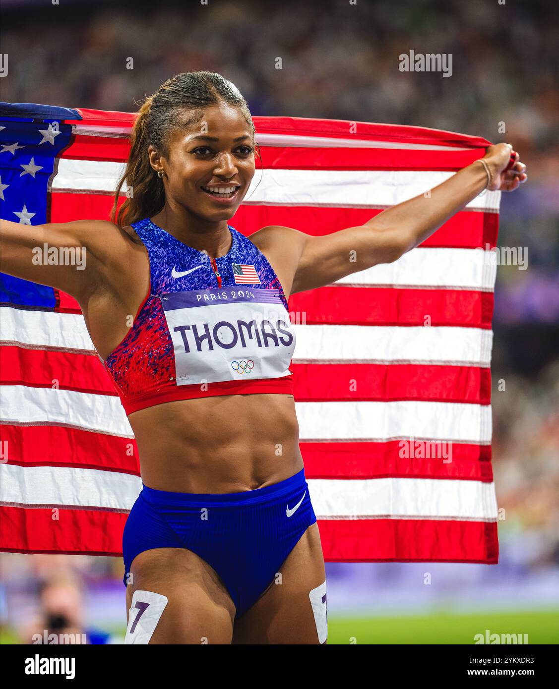 Gabrielle Thomas celebrating with her country's flag in the 200 meters ...