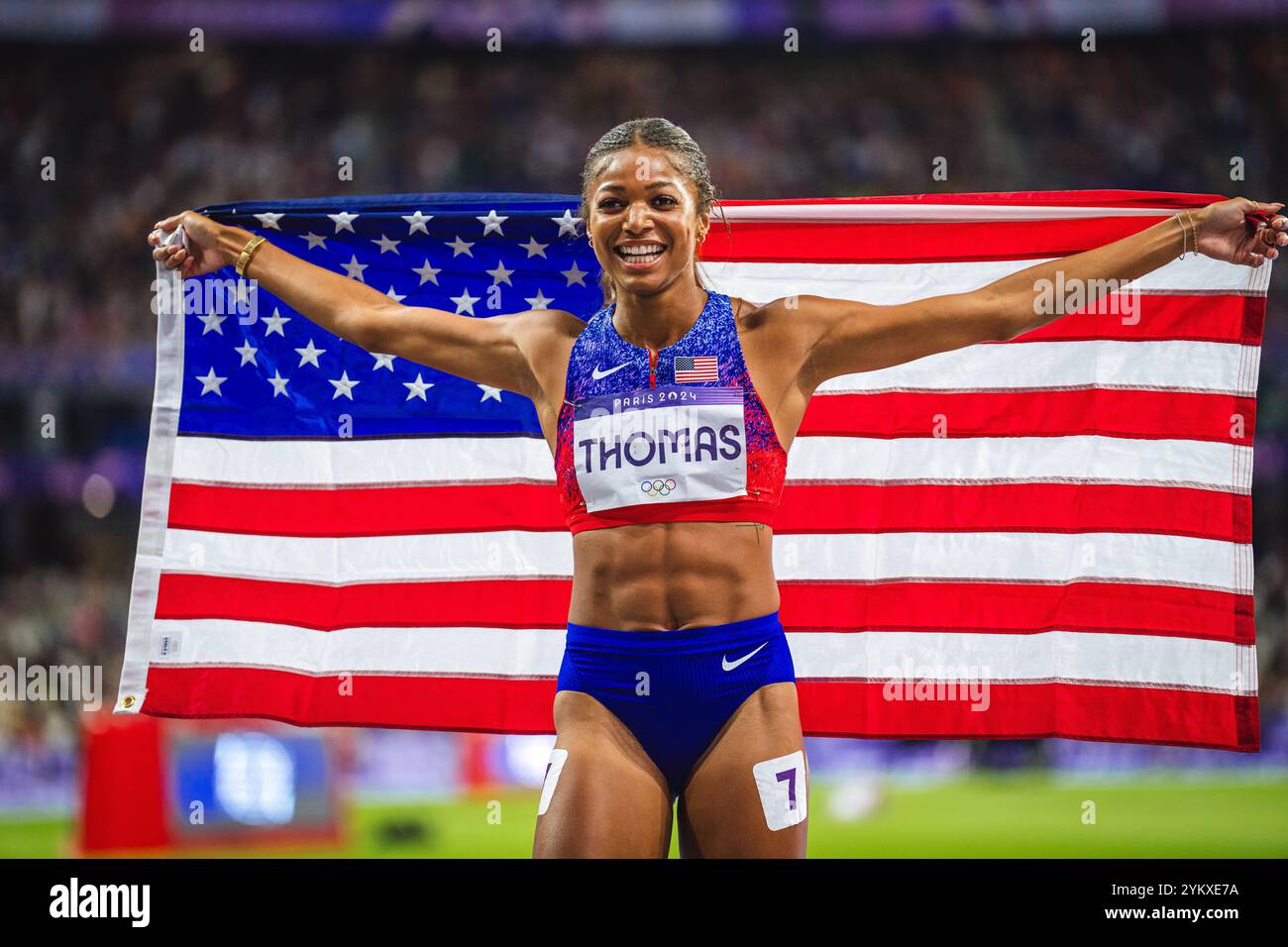 Gabrielle Thomas celebrating with her country's flag in the 200 meters ...