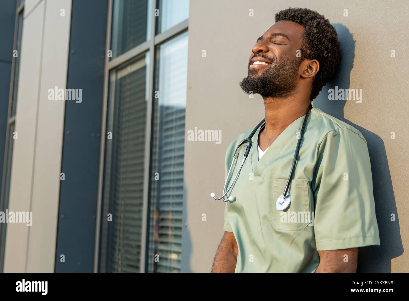 African American doctor standing outside hospital wearing uniform ...