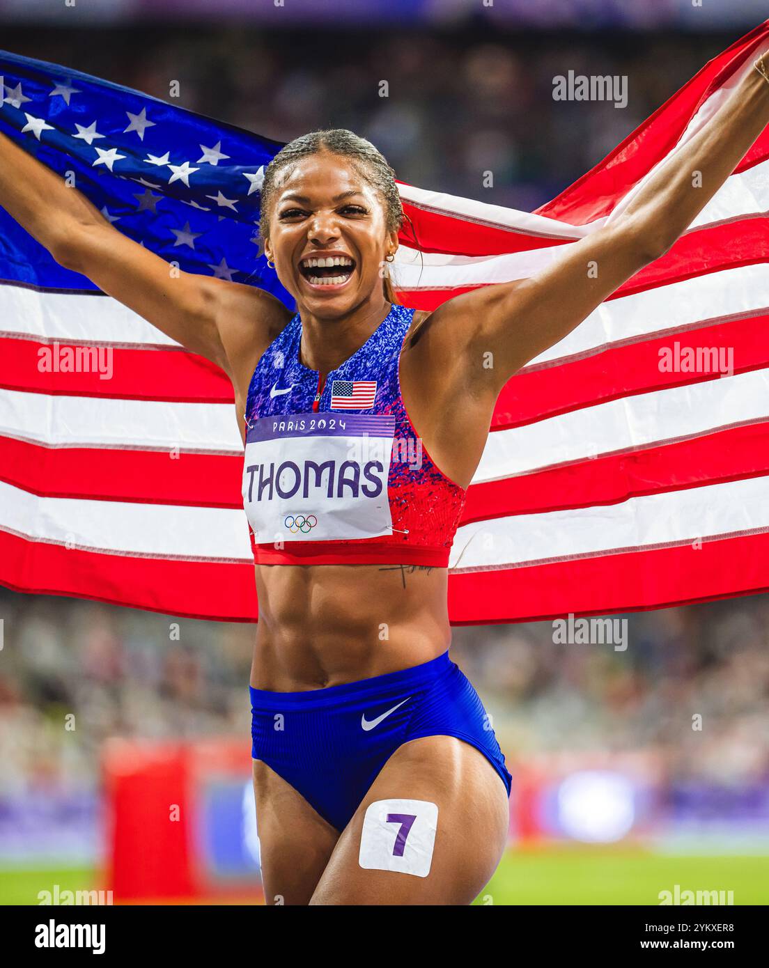 Gabrielle Thomas celebrating with her country's flag in the 200 meters ...