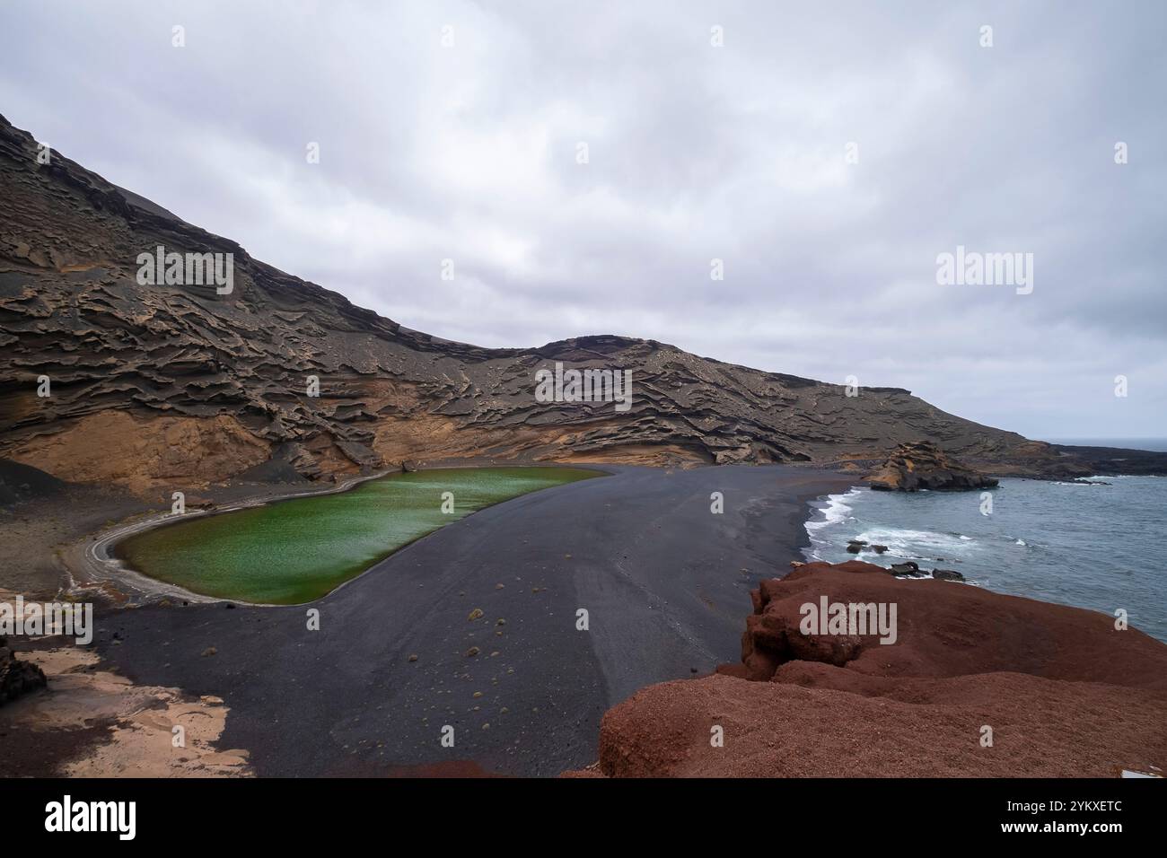 A green water lagoon, next to a beach in a volcanic landscape, green ...