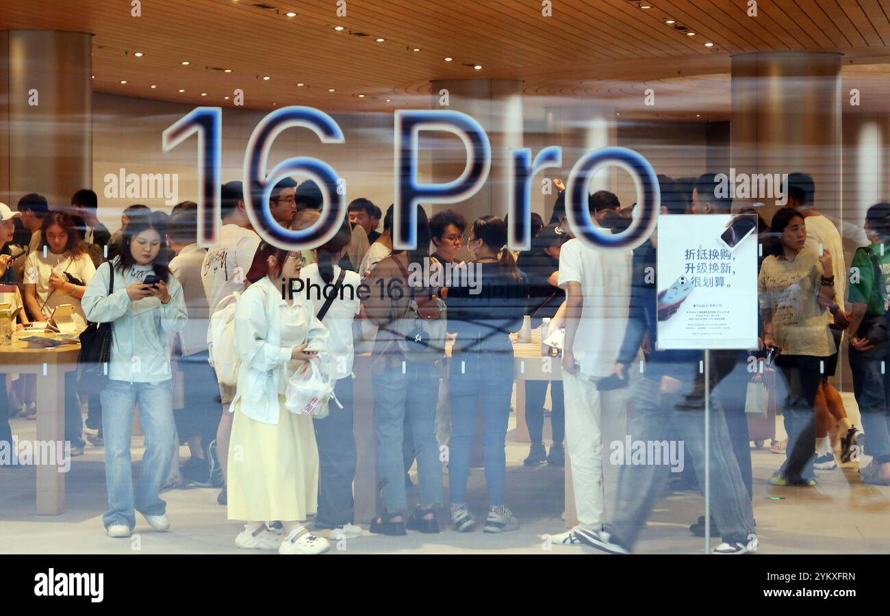 Customers shop at the largest Apple flagship store in Asia in Shanghai ...