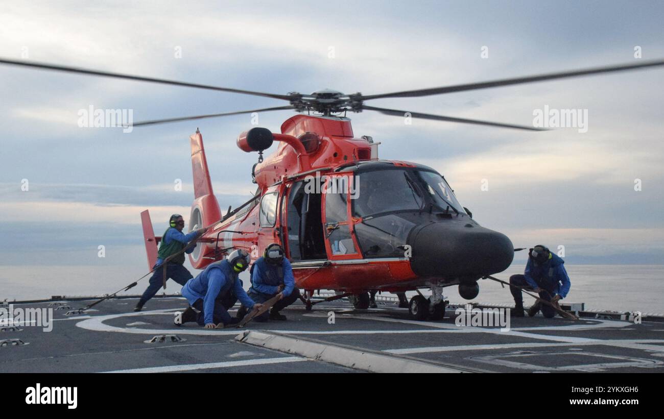 A Coast Guard Cutter Seneca (WMEC 906) tiedown crew secures an embarked ...