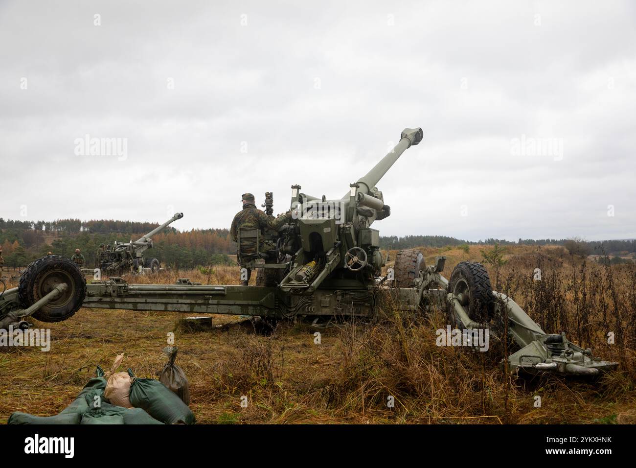 A German Army soldier fires a live round with the Italian 155mm FH70 ...