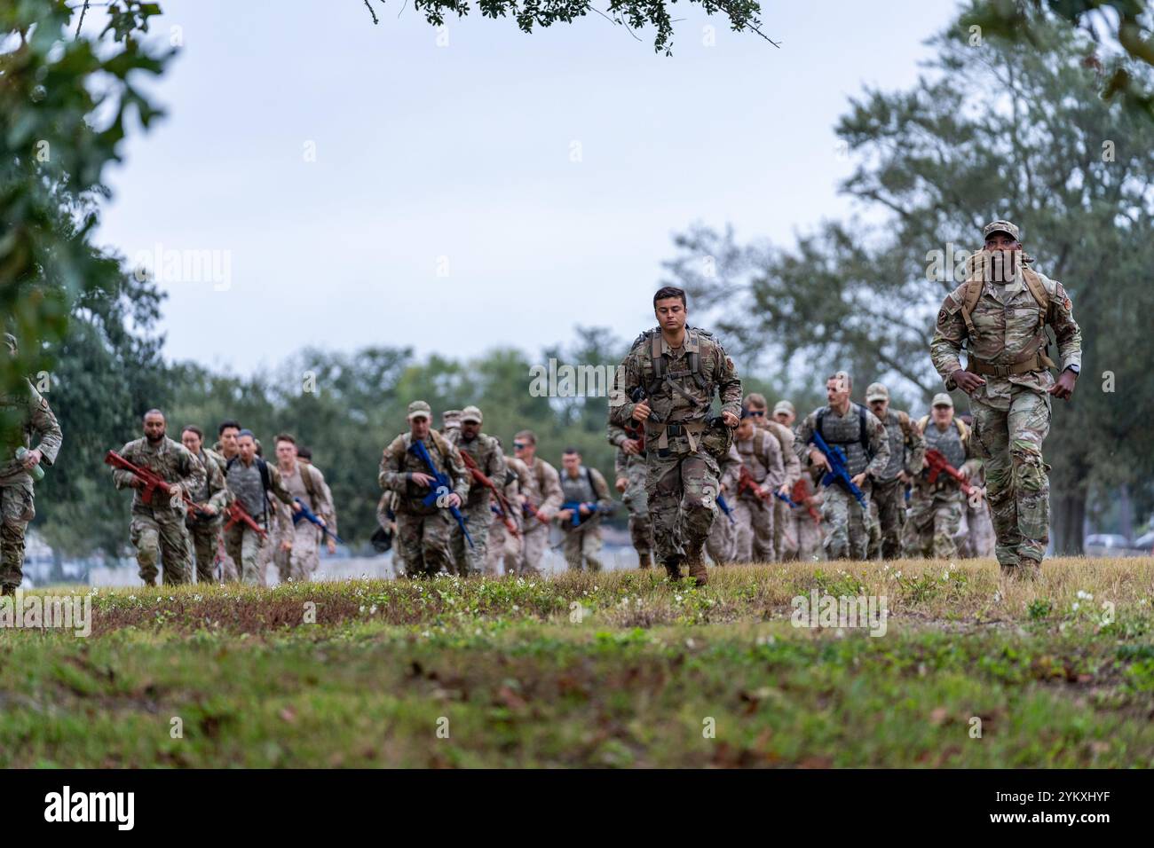 U.S. Airmen and Marines run to their first objective during Warrior Day ...