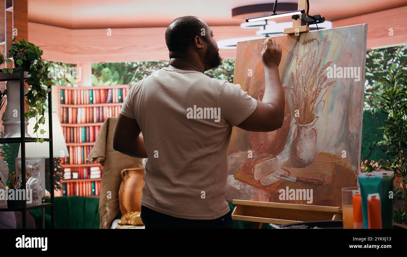 African american artist using his skill to paint a new creation in art ...
