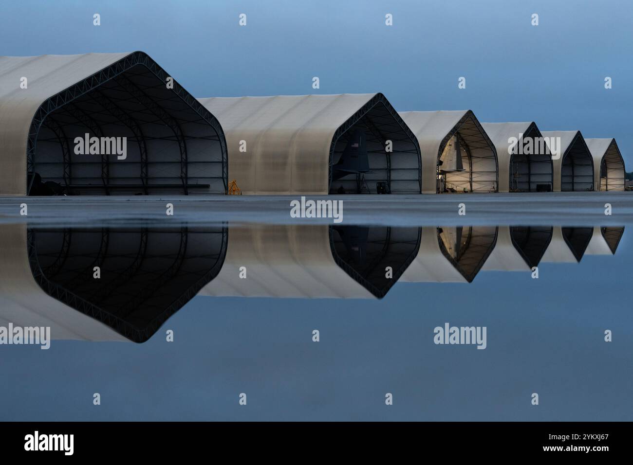 Three C-130 Hercules aircraft sit in hangars at the Warner Robins Air ...