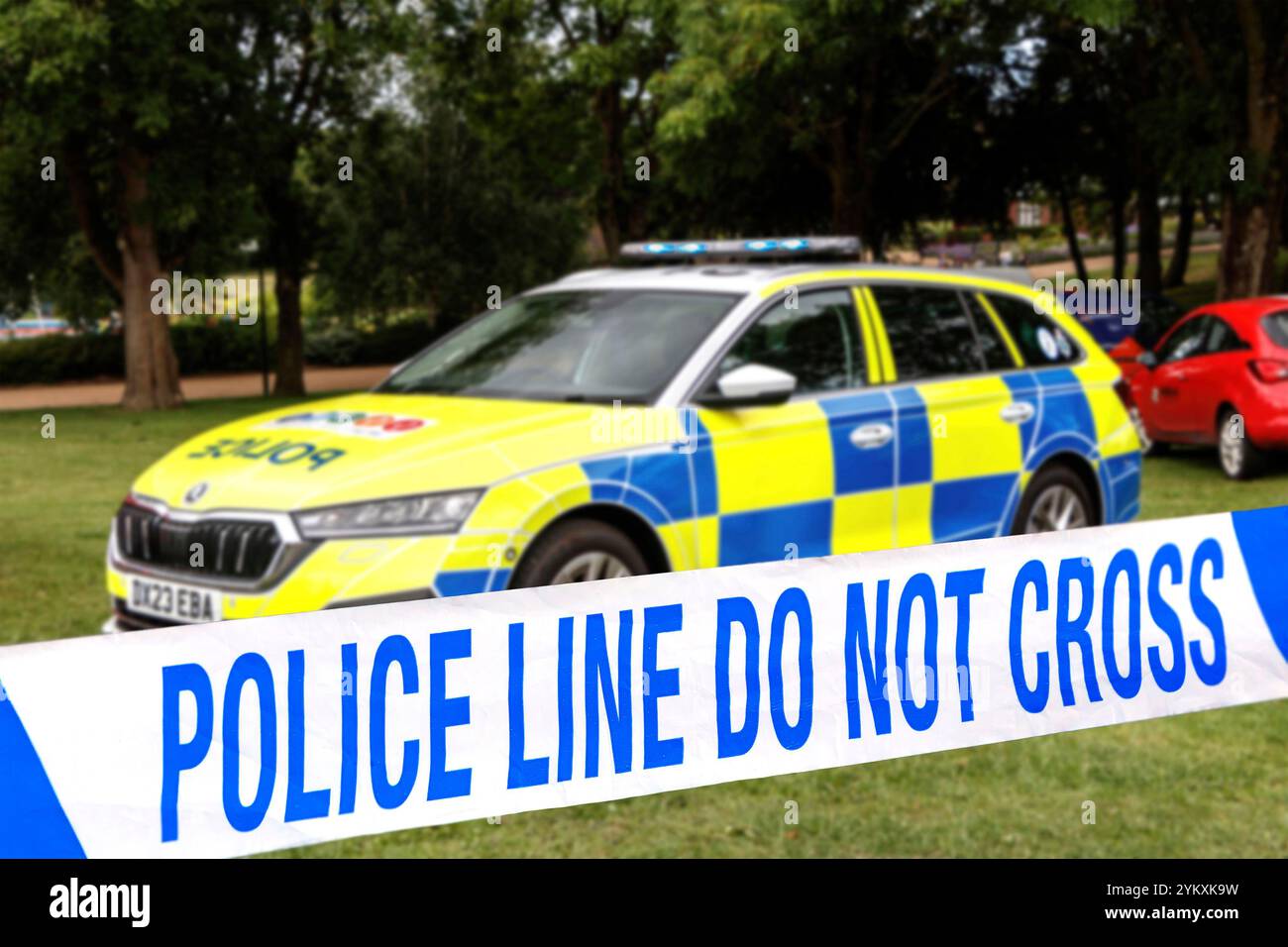 Blue and white police line do not cross crime scene tape in focus with ...