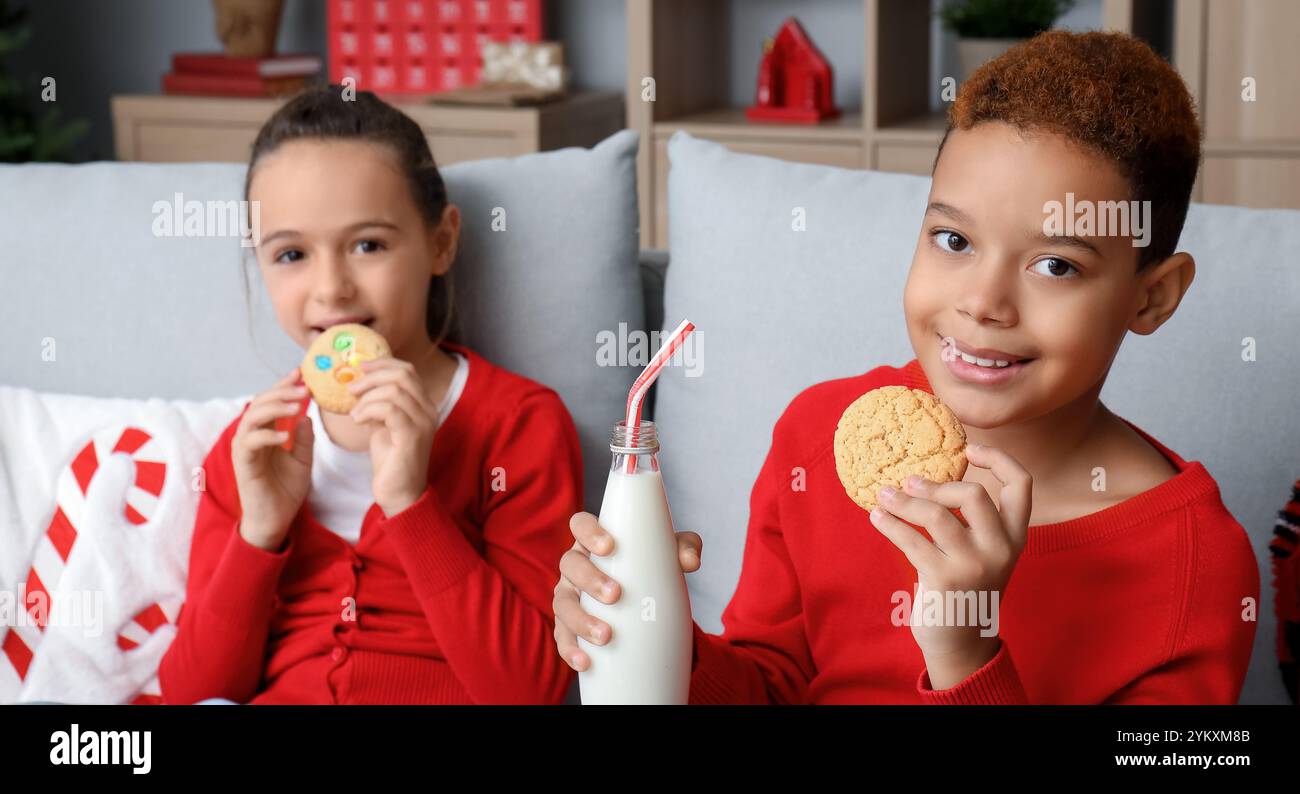 Little children eating cookies with milk at home on Christmas eve Stock ...