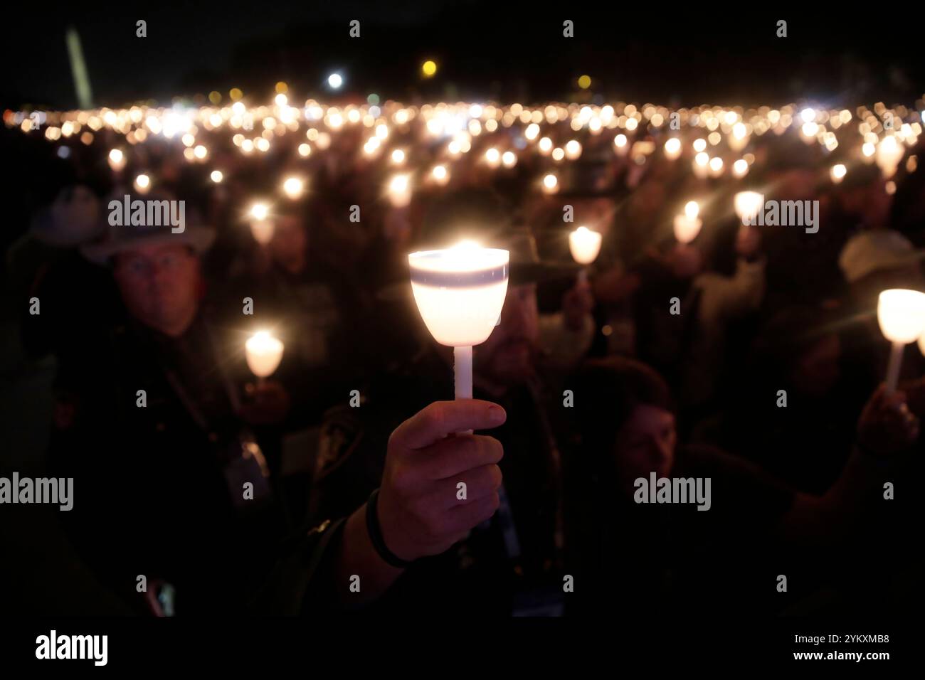 Lighted candles are elevated by thousands of attendees during the 35th ...