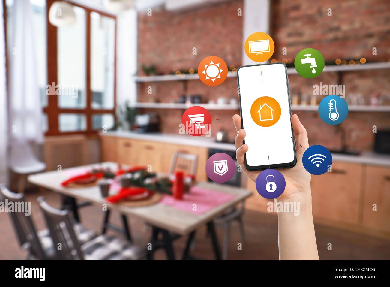 Hand holding mobile phone with open application of smart home ...