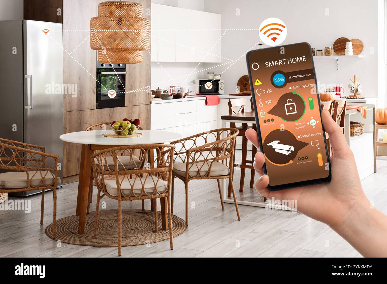 Hand holding mobile phone with open application of smart home ...