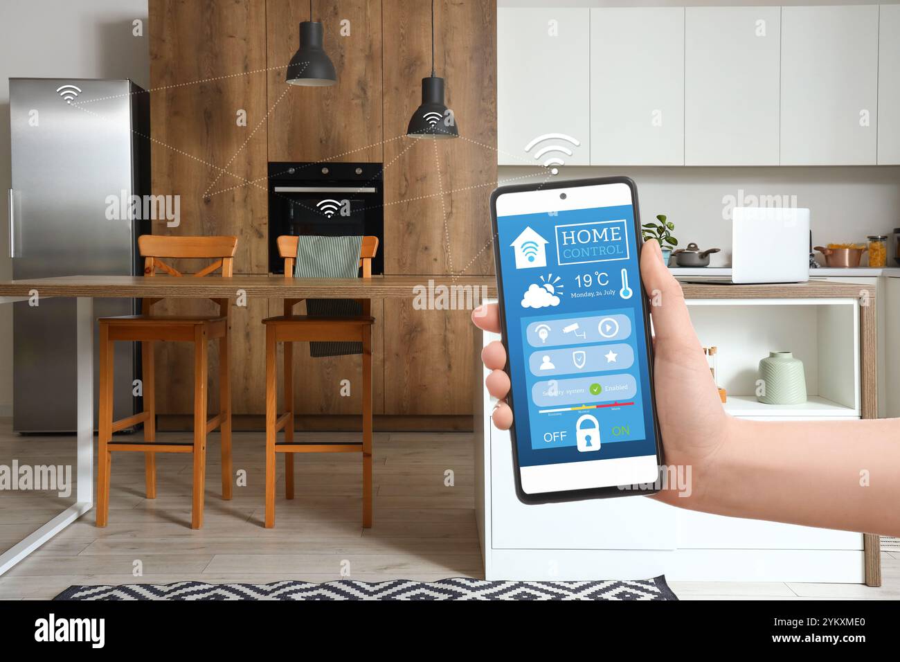 Hand holding mobile phone with open application of smart home ...
