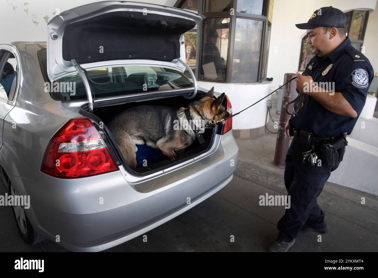 U.S. Customs and Border Protection officers screen border crossers as ...