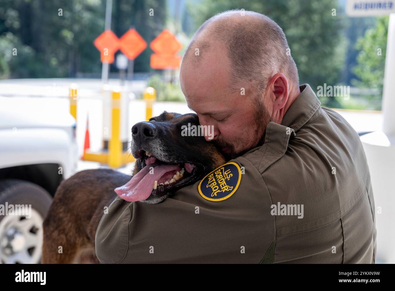 A Spokane Sector Border Patrol Agent, along with his canine partner, at ...