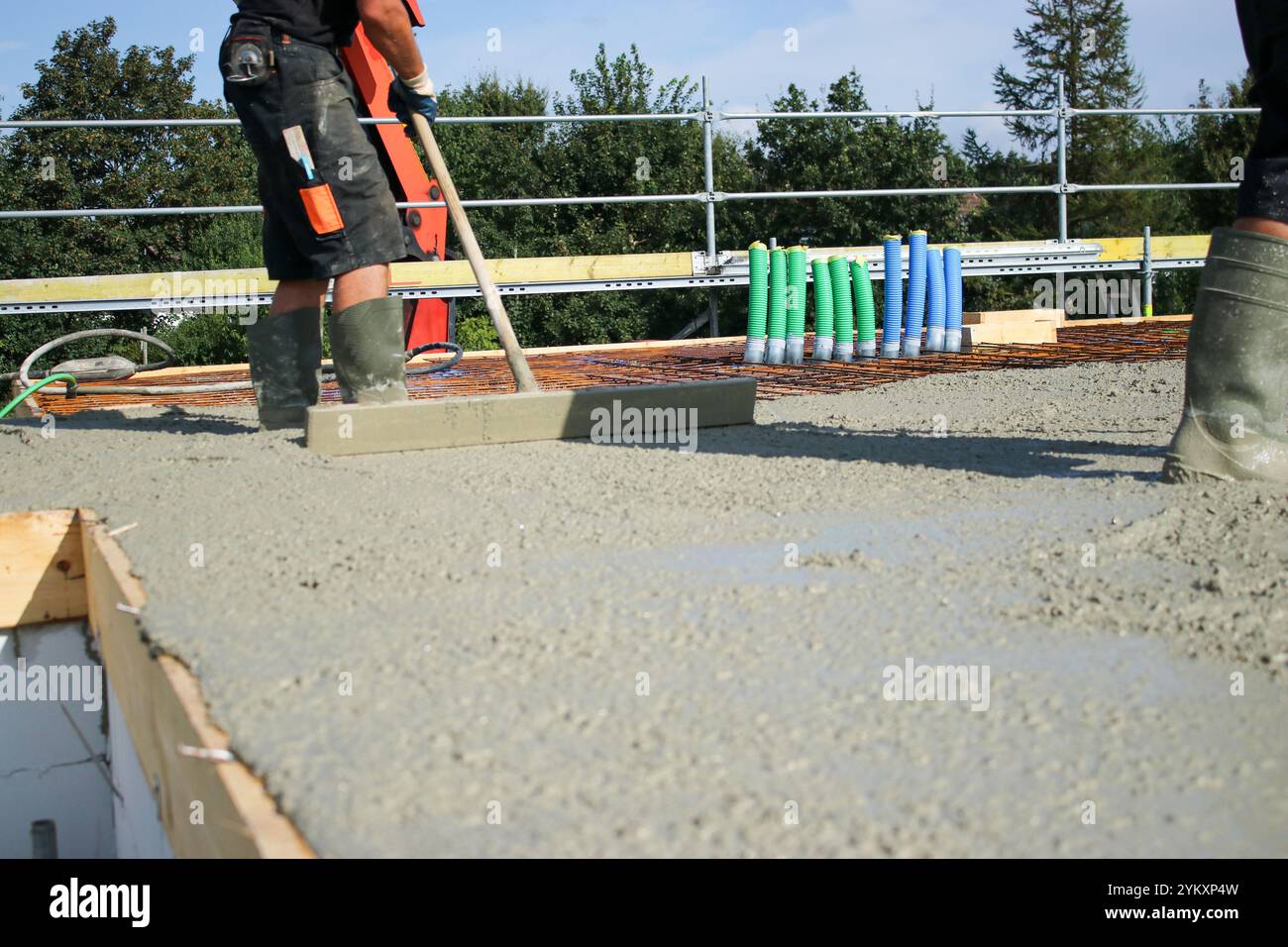 Workers filling the second floor ground with concrete, core and shell ...