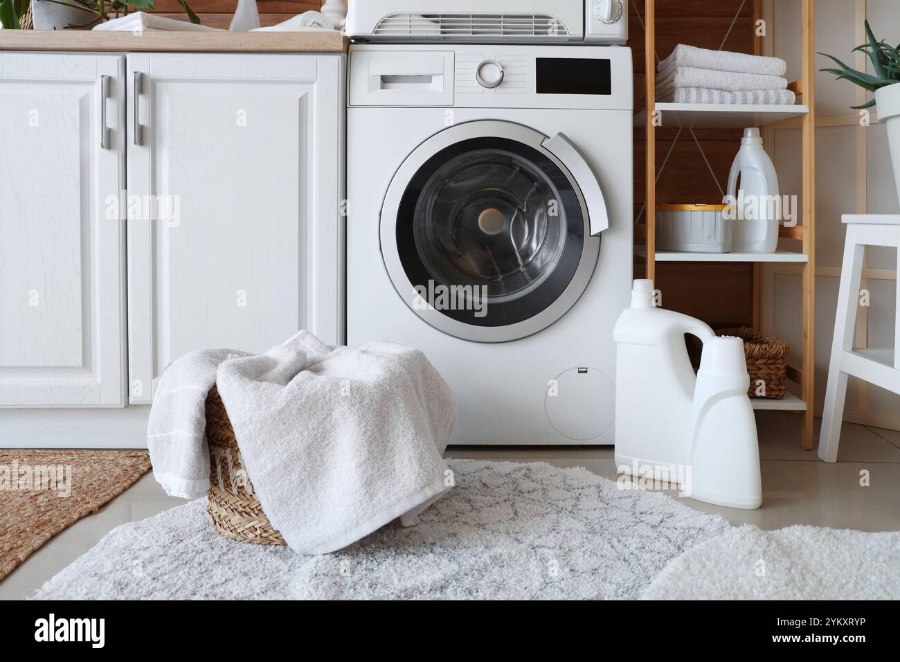 Interior of home laundry room with modern washing machine, counter ...