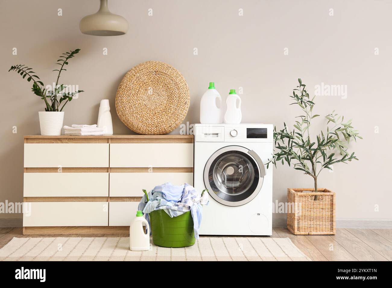 Interior of home laundry room with washing machine, chest of drawers ...