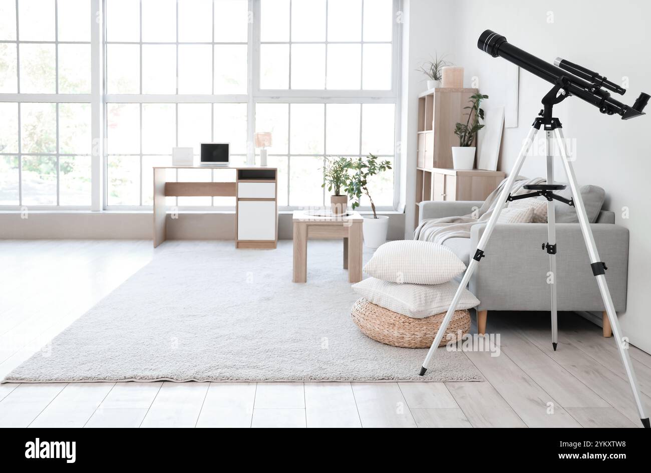 Interior of living room with grey sofa and modern telescope Stock Photo ...