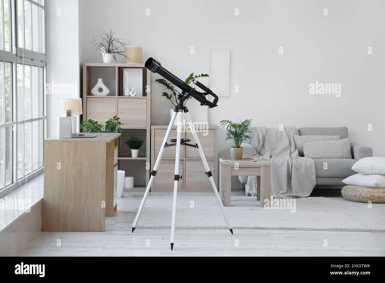 Interior of living room with modern telescope near window Stock Photo ...