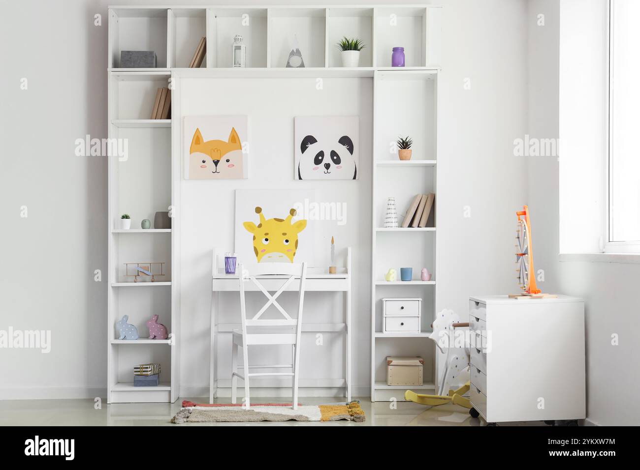 Interior of children's room with table, shelving units and animal ...